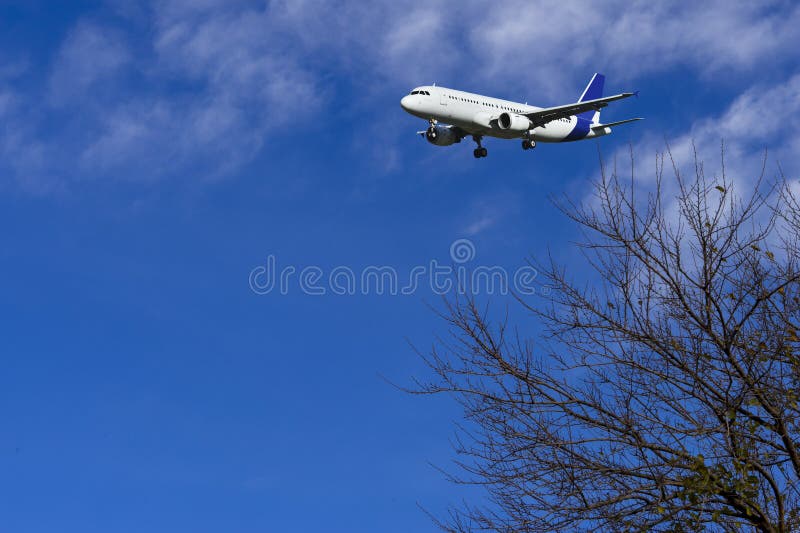 A Passenger Plane is Flying in a Beautiful Blue Sky with White Clouds ...