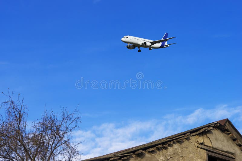 A Passenger Plane is Flying in a Beautiful Blue Sky with White Clouds ...