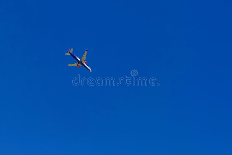 A Passenger Plane is Flying Low in the Blue Sky . the Concept of ...