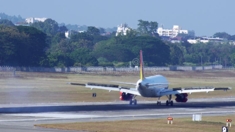 A Passenger Plane Landing on Runway. Back View on Landing Airplane ...