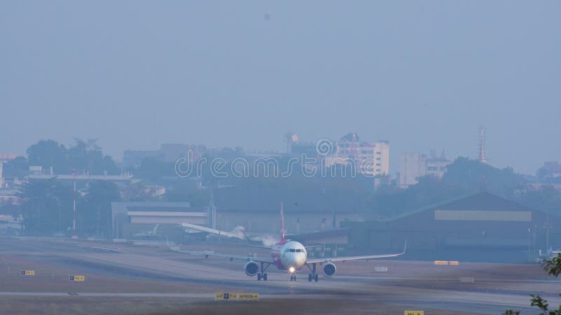 A Passenger Plane Landing on Runway. Back View on Landing Airplane ...