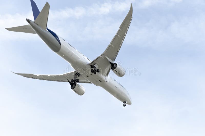 A Passenger Plane with Two Jet Engines Flying Low Stock Image - Image ...