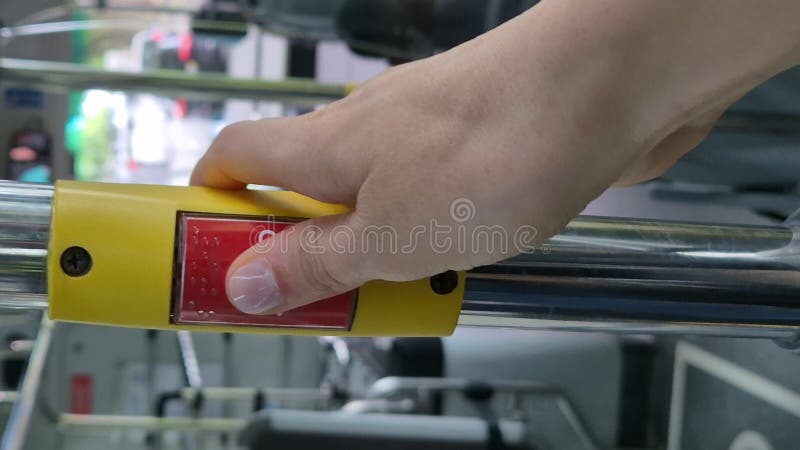 A Passenger Presses the Red "STOP" Button Inside a City Bus Stock ...