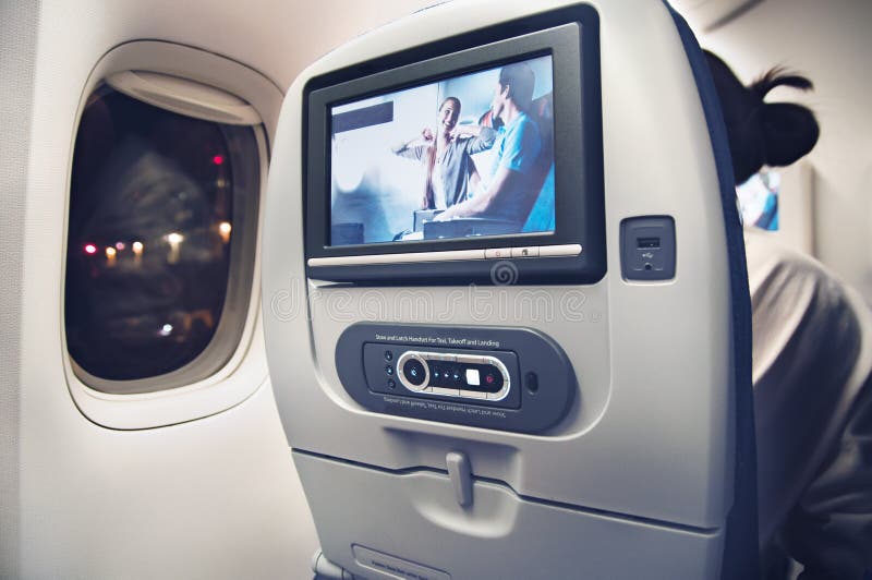 Passenger Seat with a Multimedia Screen in the Airplane Editorial Stock ...