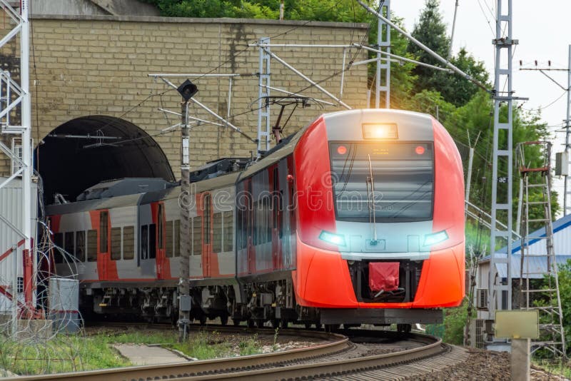 Passenger Suburban Train Leaving the Tunnel with Headlights on Stock ...