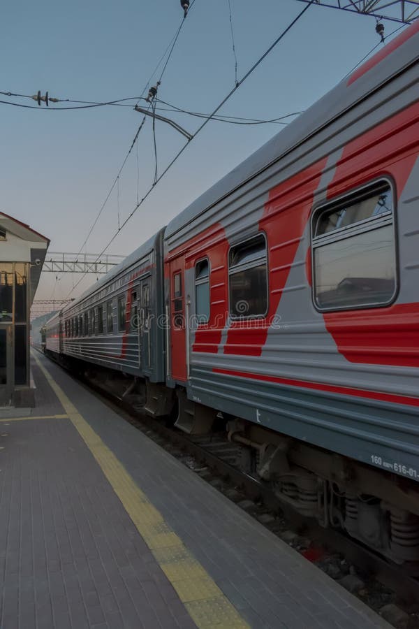 Passenger Train on the Platform of the Station Lit by the Setting Sun ...