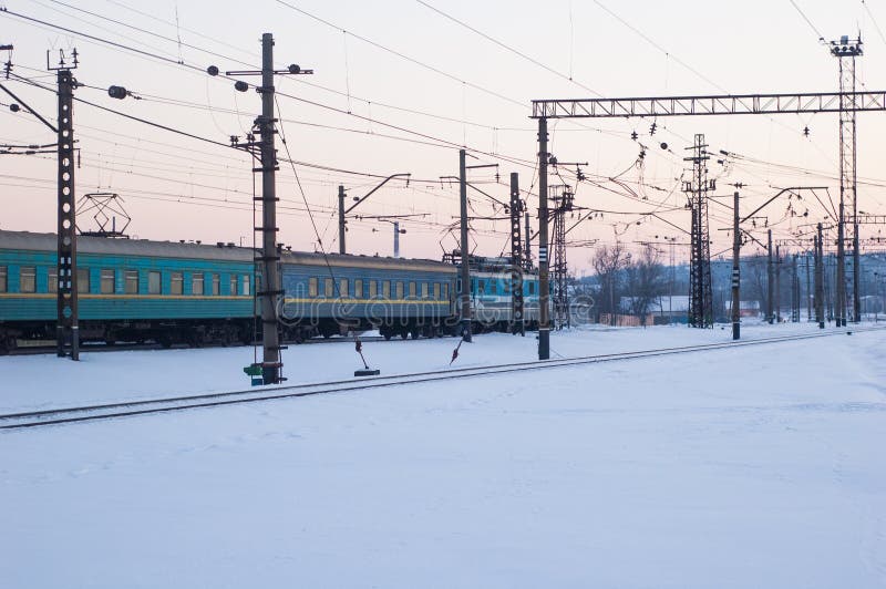 The Passenger Train Travels through Snow-covered Rails Stock Photo ...
