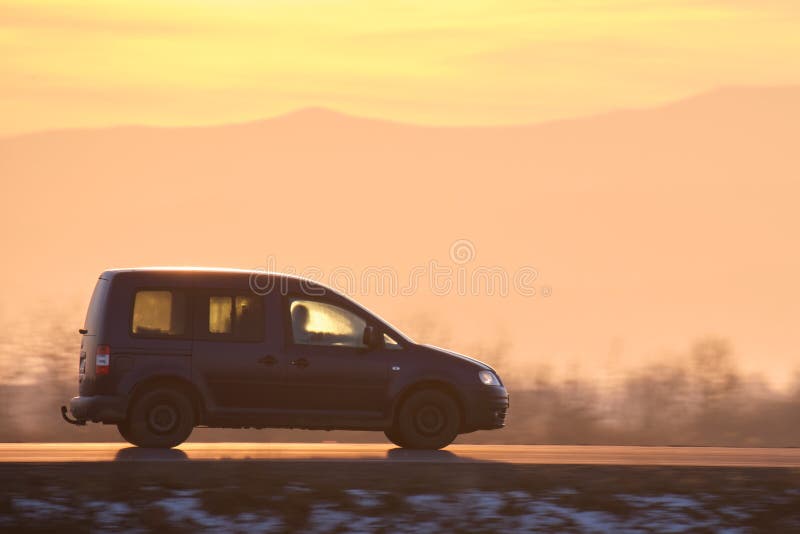 Passenger Van Driving Fast on Intercity Road at Sunset. Highway Traffic ...