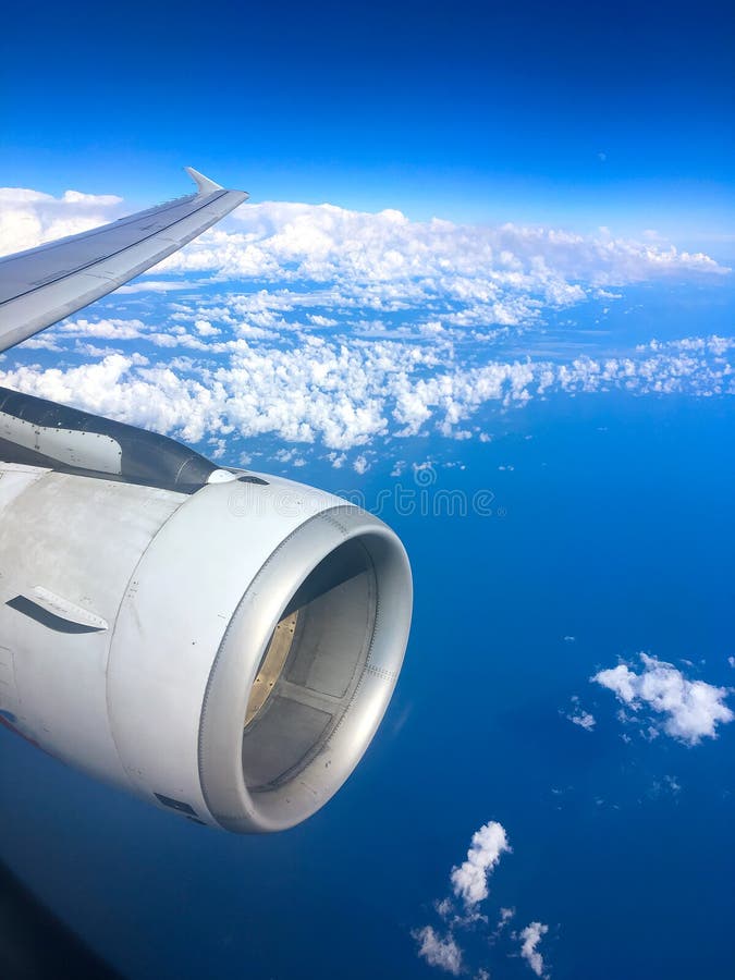 Passenger View through the Window of a Jet Plane Showing Sky, Clouds ...