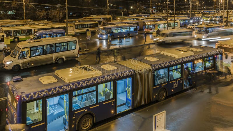 Passengers Waiting and Boarding Buses at the Bus Terminal Stock Photo ...