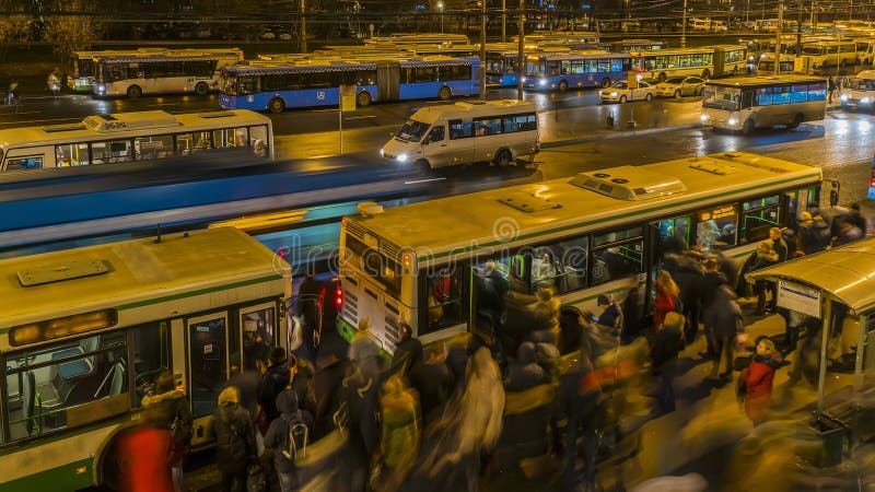 Passengers Waiting and Boarding Buses at the Bus Terminal Stock Photo ...