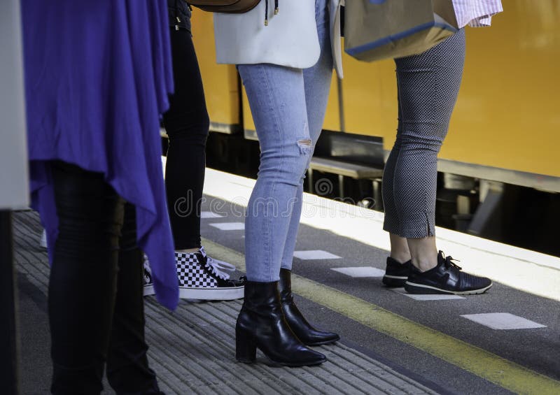 Passengers are Waiting for the Train that is Approaching the Platform ...