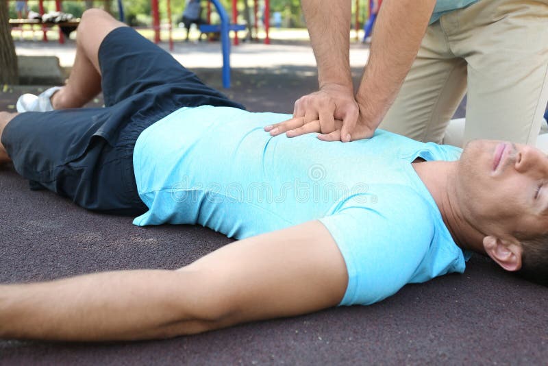 Passerby Performing CPR on Unconscious Man Outdoors. First Aid Stock ...