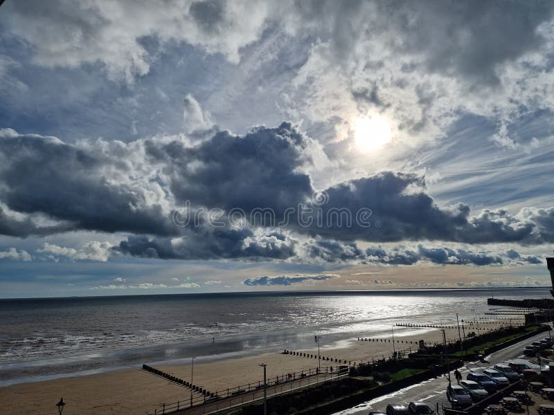 Passing clouds at sea stock image. Image of evening - 262221199