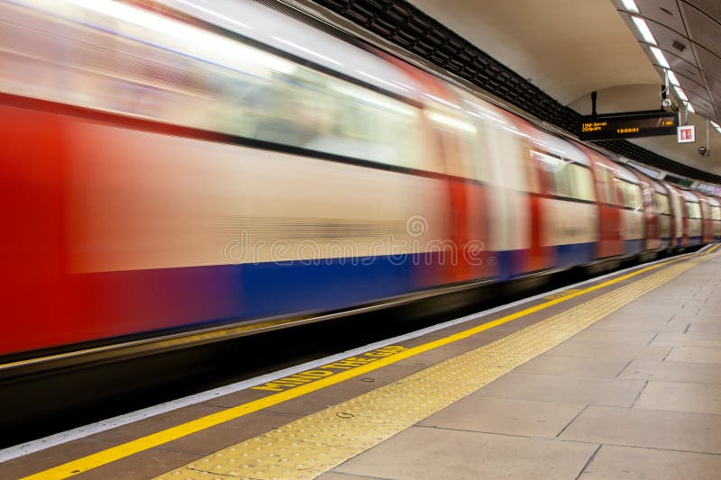 A Passing High Speed Passenger Train Flying Past a Train Station ...