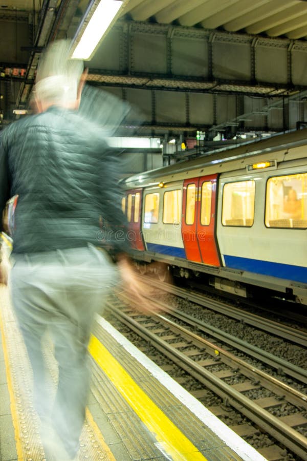 A Passing High Speed Passenger Train Flying Past a Train Station ...