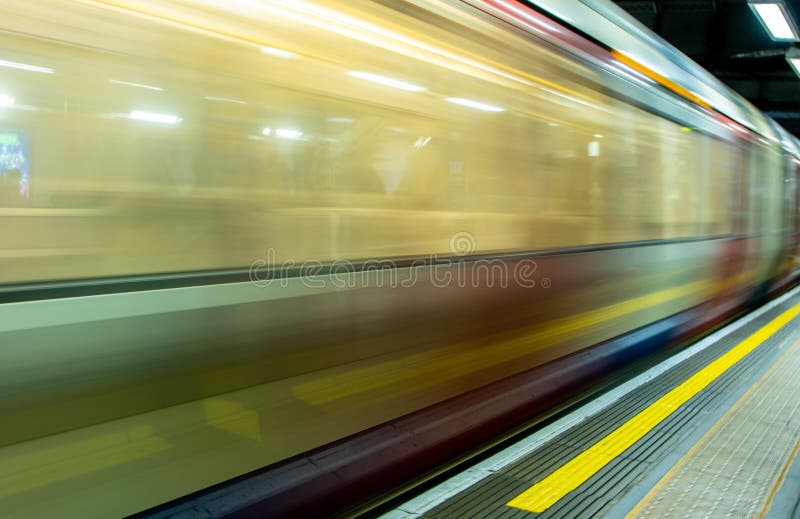 A Passing High Speed Passenger Train Flying Past a Train Station ...