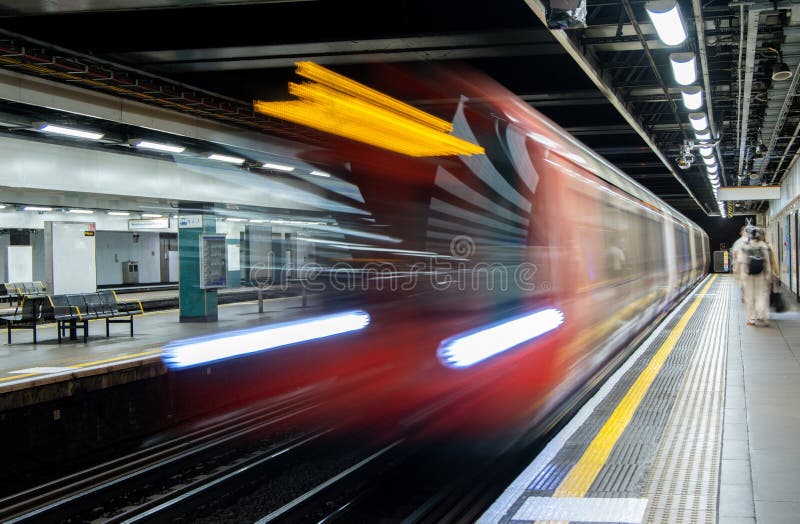 A Passing High Speed Passenger Train Flying Past a Train Station ...