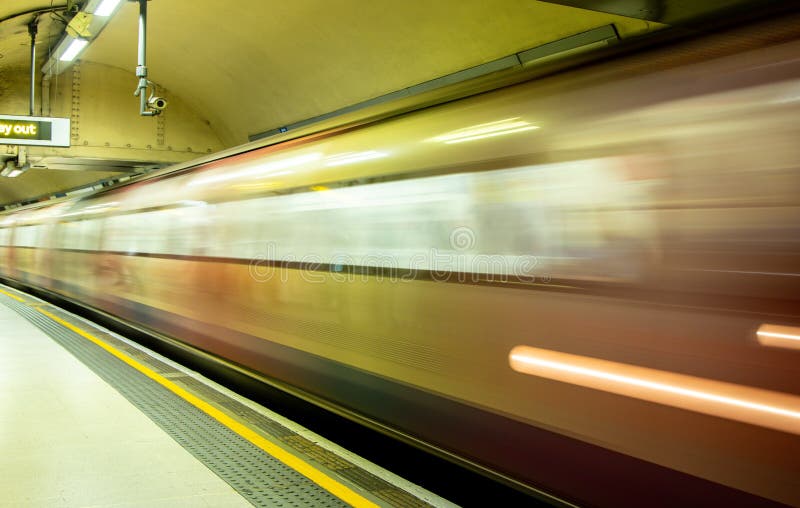 A Passing High Speed Passenger Train Flying Past a Train Station ...