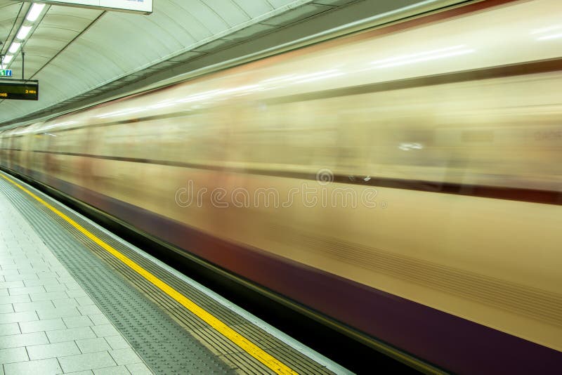 A Passing High Speed Passenger Train Flying Past a Train Station ...
