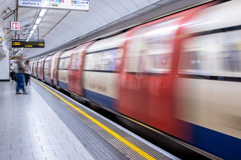 A Passing High Speed Passenger Train Flying Past a Train Station ...