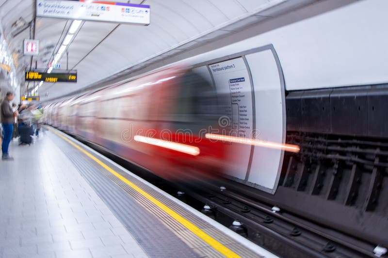 A Passing High Speed Passenger Train Flying Past a Train Station ...