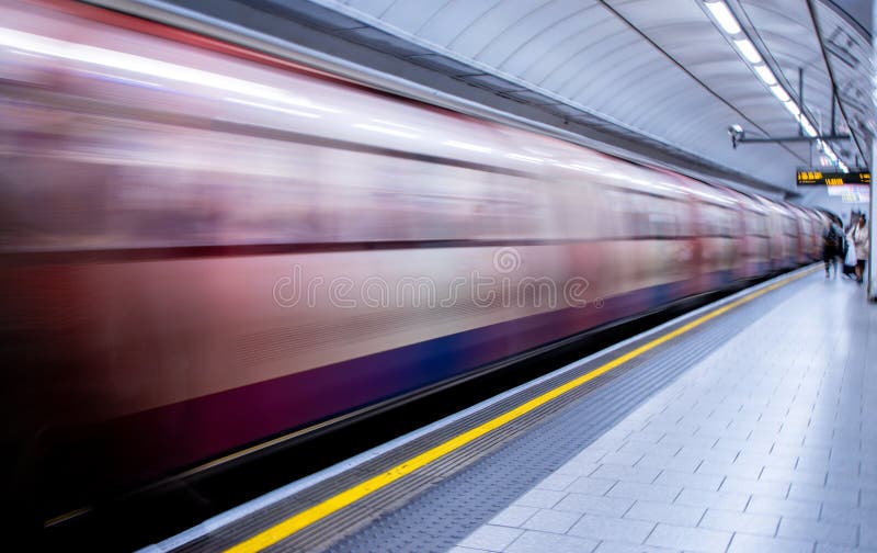 A Passing High Speed Passenger Train Flying Past a Train Station ...