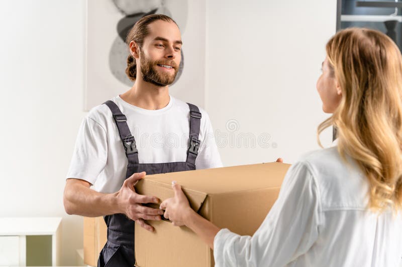 Worker of a Delivery Services Office Passing the Package To the ...