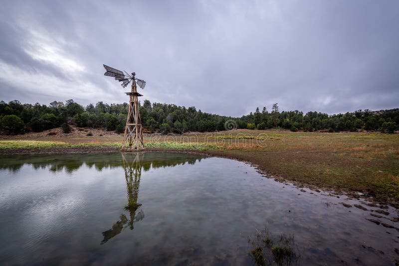 A Lone, Weathered Windmill Stands Tall. Stock Photo - Image of morning ...
