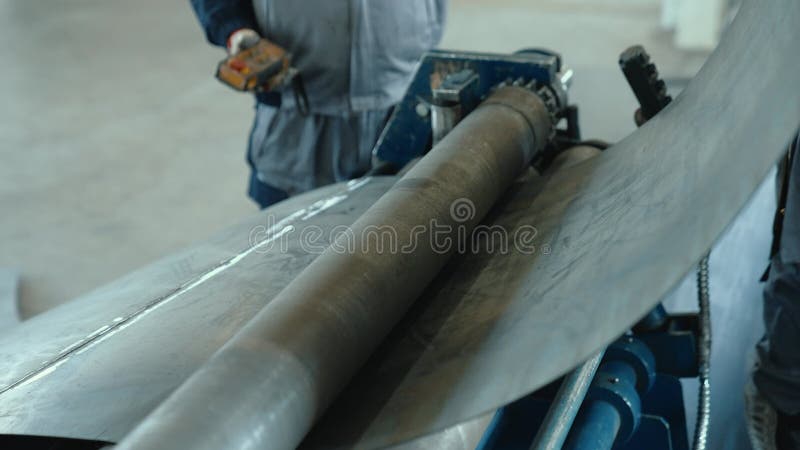 Passing a Sheet of Metal through a Round Shaft. Metal Rolling Machine ...