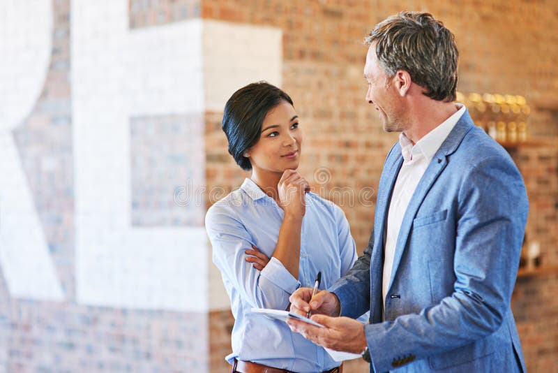 Passing on Some of His Experience. a Coworkers Talking Together Over a ...