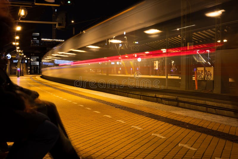 Passing Train Leaving Light Trail in the Train Station Stock Photo ...