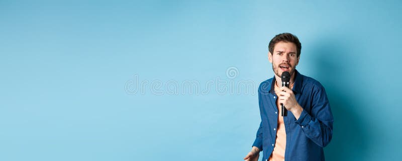 Passionate Singer Looking at Camera, Singing in Microphone, Playing ...