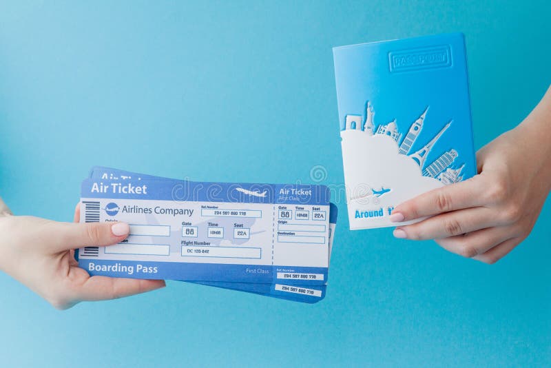 Passport And Air Ticket In Woman Hand On A Blue Background Travel