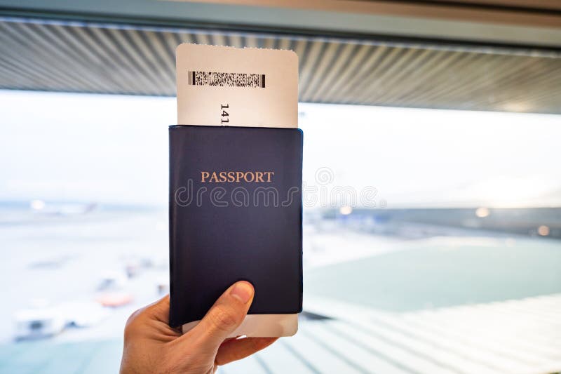 Passport with Boarding Pass Held in Hand, at Airport Stock Photo ...