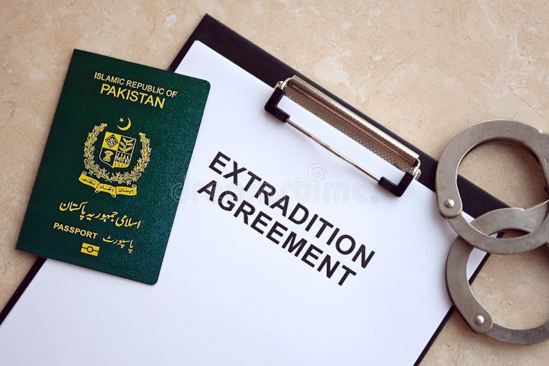 Passport of Pakistan and Extradition Agreement with Handcuffs on Table ...