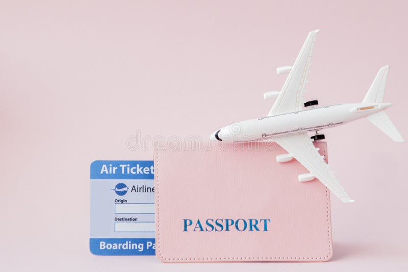 Passport Plane And Air Ticket On A Pink Background Travel Concept