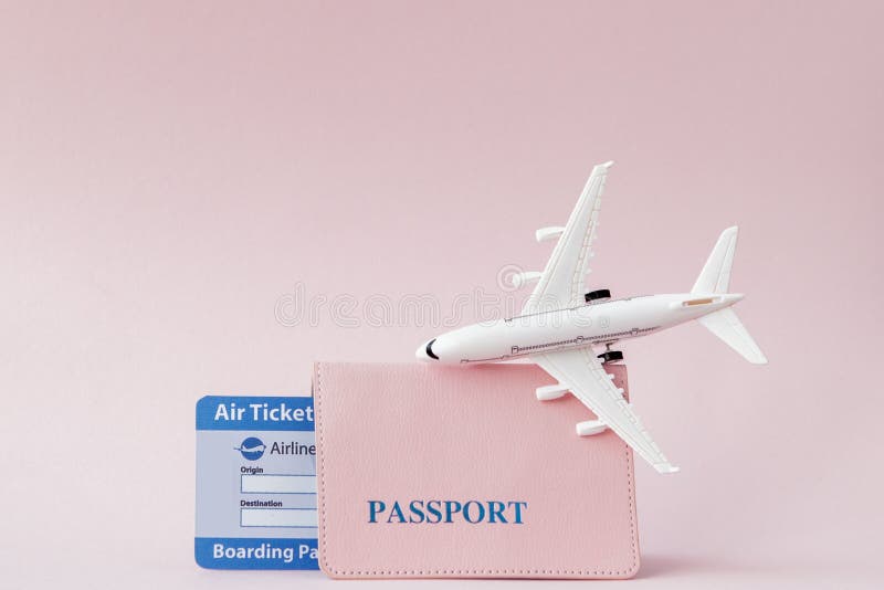Passport Plane And Air Ticket On A Pink Background Travel Concept