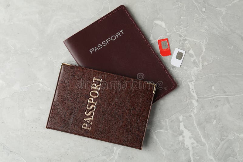 Passports and SIM Cards on Grey Marble Table, Flat Lay Stock Image ...