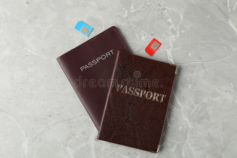 Passports and SIM Cards on Grey Marble Table, Flat Lay Stock Photo ...