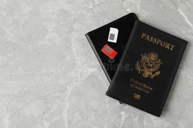 Passports and SIM Cards on Grey Marble Table, Flat Lay. Space for Text ...