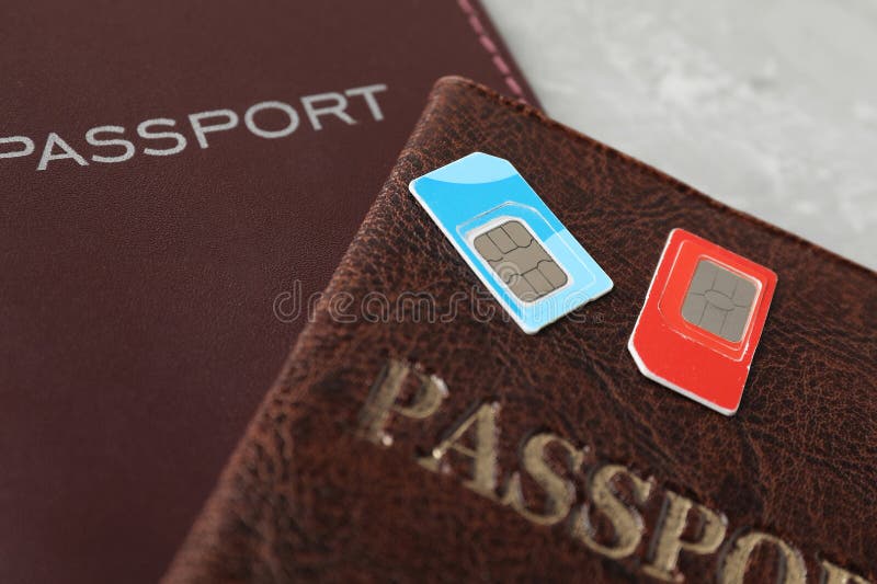 Passports and SIM Cards on Grey Table, Closeup Stock Image - Image of ...