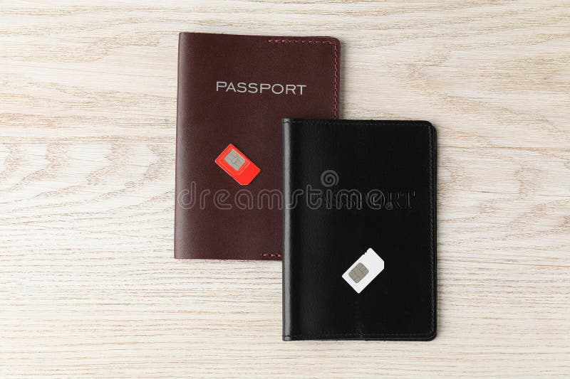 Passports and SIM Cards on Wooden Table, Flat Lay Stock Photo - Image ...
