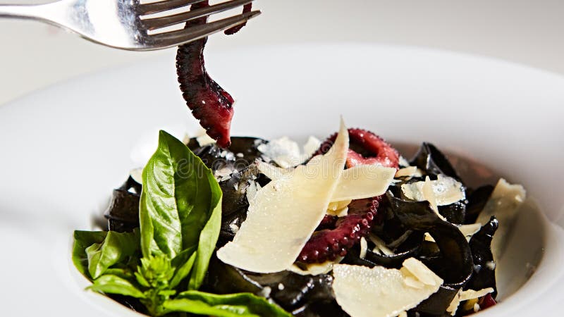 Pasta with Black Cuttlefish Ink, Octopuses and Parmesan. Stock Photo ...