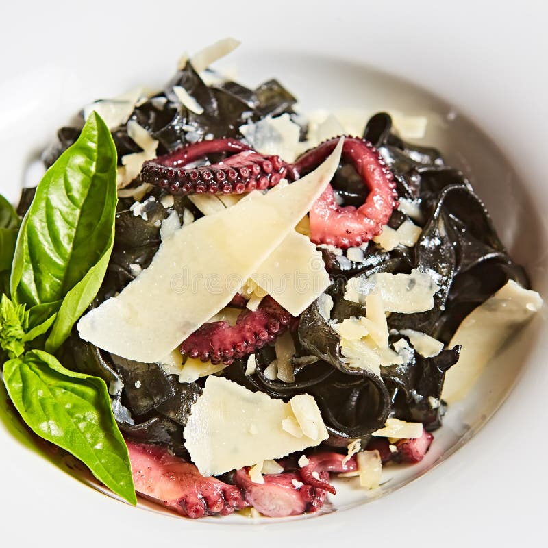 Pasta with Black Cuttlefish Ink, Octopuses and Parmesan. Stock Photo ...