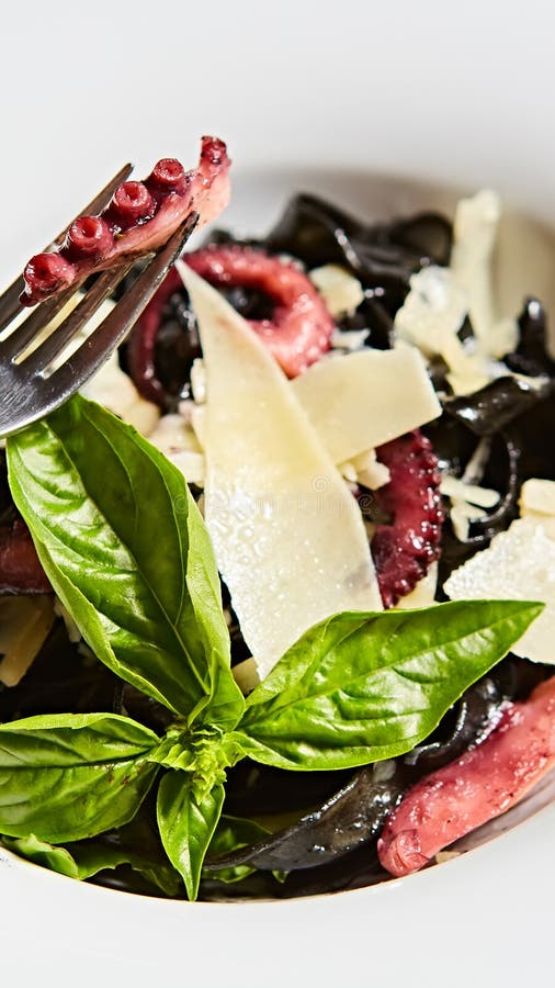 Pasta with Black Cuttlefish Ink, Octopuses and Parmesan. Stock Image ...