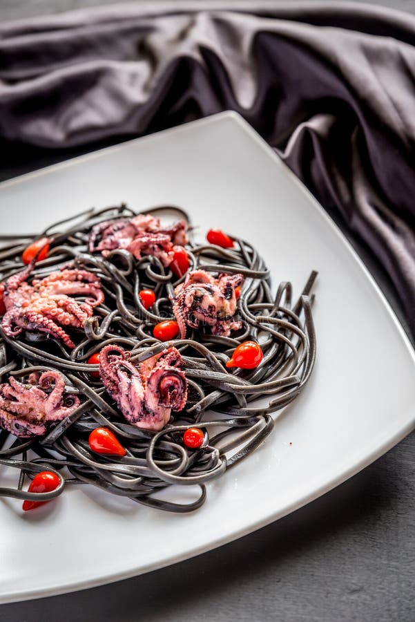Pasta with Black Cuttlefish Ink and Small Octopuses Stock Photo - Image ...