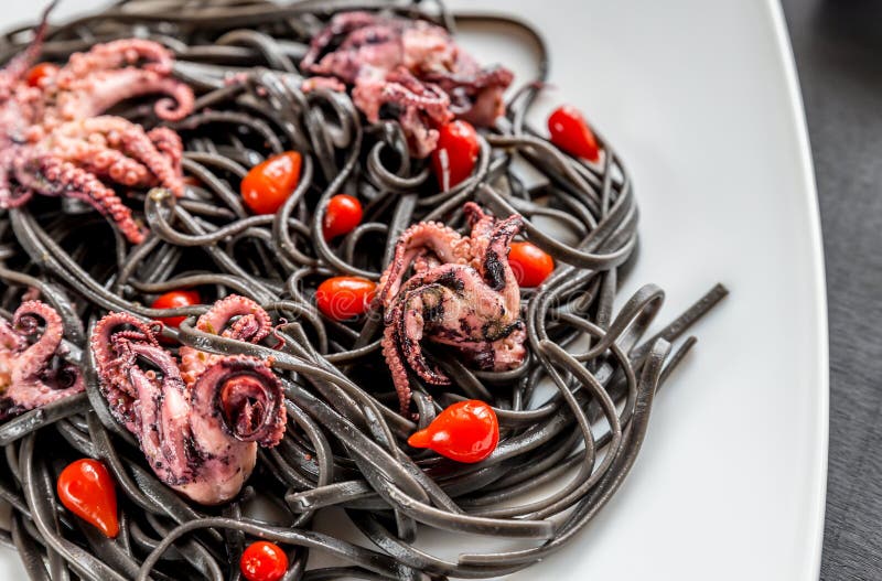Pasta with Black Cuttlefish Ink and Small Octopuses Stock Photo - Image ...