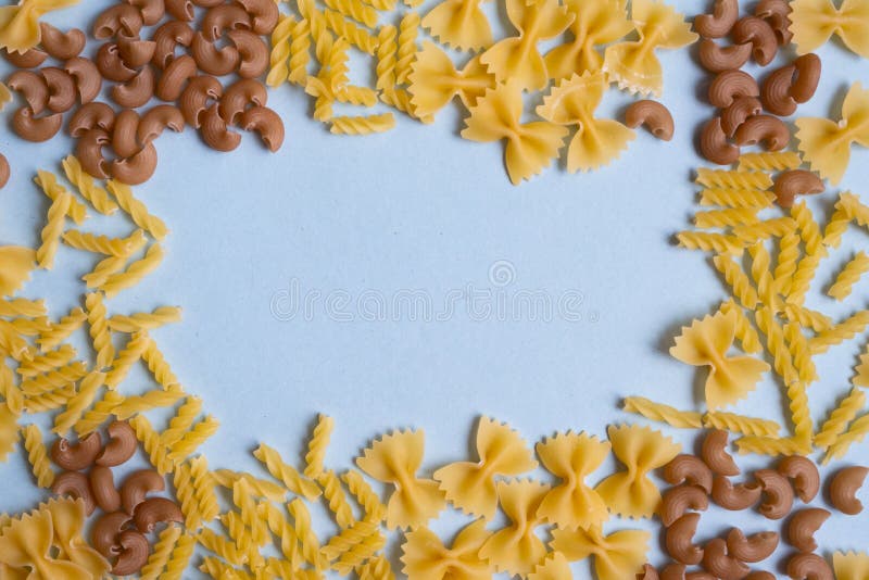 Pasta on a Blue Surface. FlatLay. Copy Space. Top View Stock Photo ...