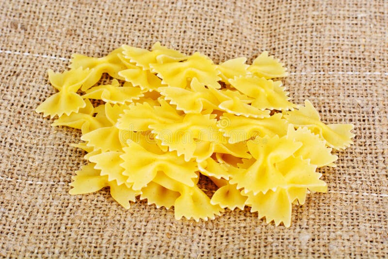 Pasta Bows on Brown Background Stock Image - Image of healthy, yellow ...